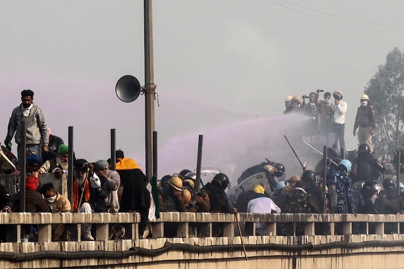 Indian police fire tear gas as protesting farmers march to capital ...